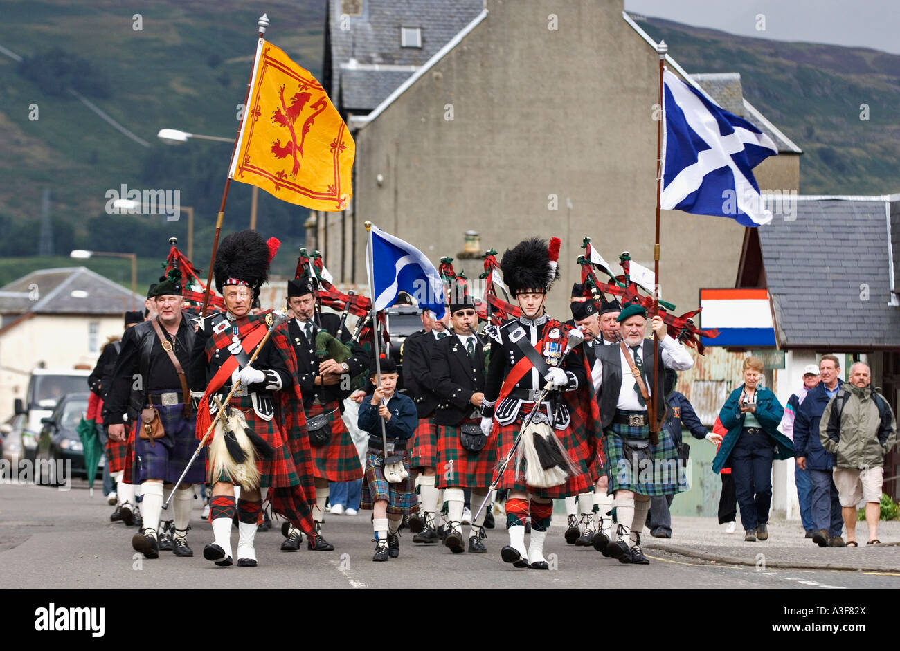 Alloa Bowmar Pipe Band Marching though Main Street of Scottish Village ...
