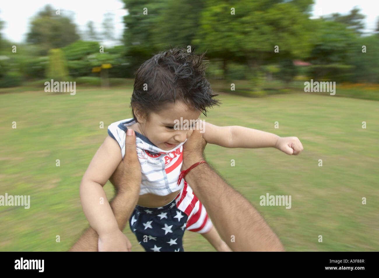 Close-up of a man's hand swinging a boy in air Stock Photo - Alamy