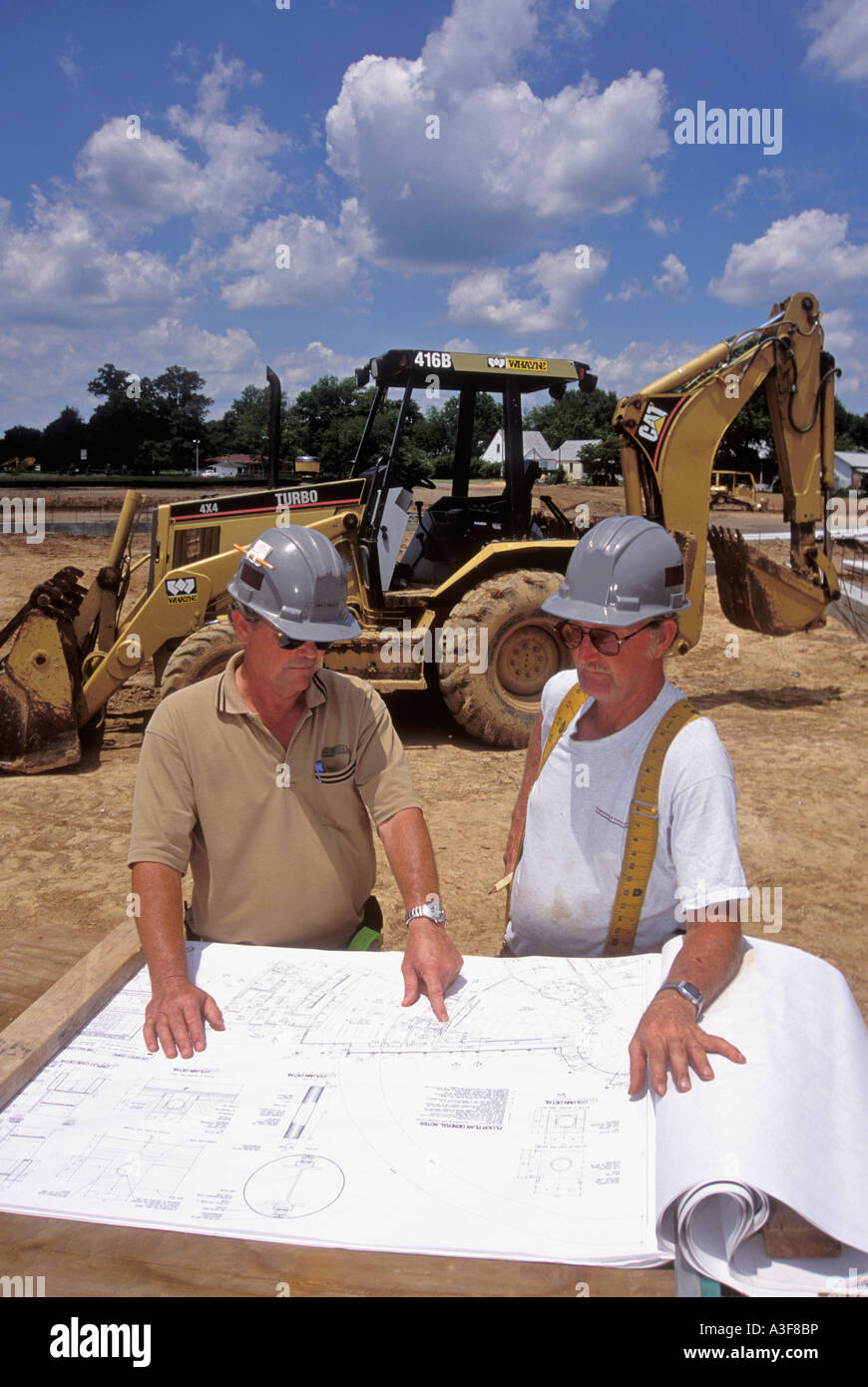 Engineer Pointing Out Detail on Blueprint To Construction Supervisor at ...