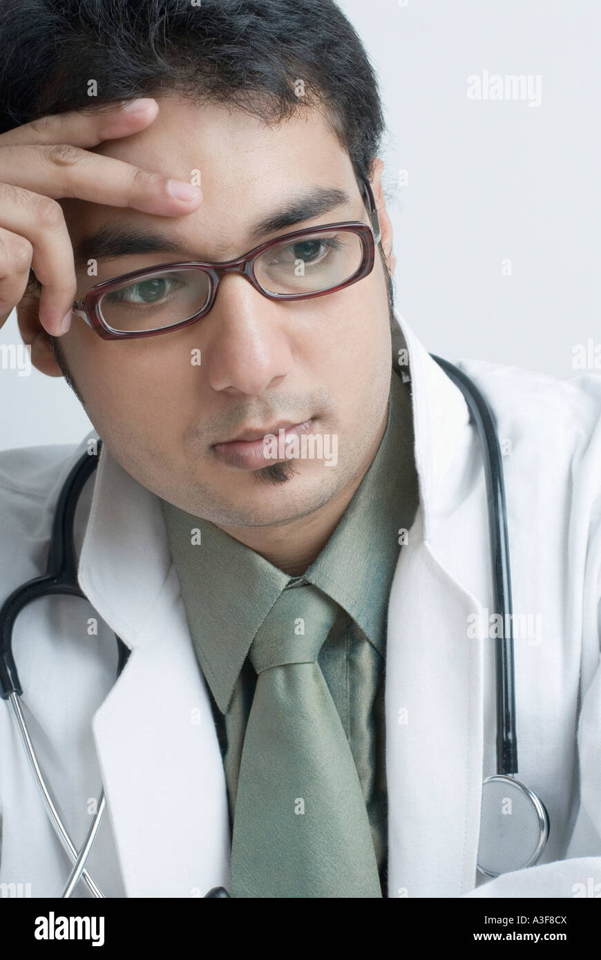 Close-up of a male doctor thinking Stock Photo - Alamy