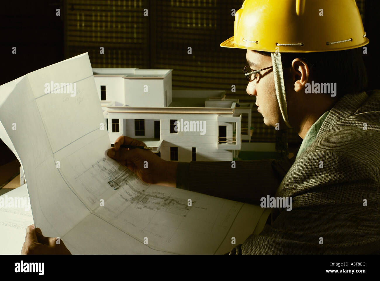 Side profile of an architect examining a blueprint Stock Photo - Alamy