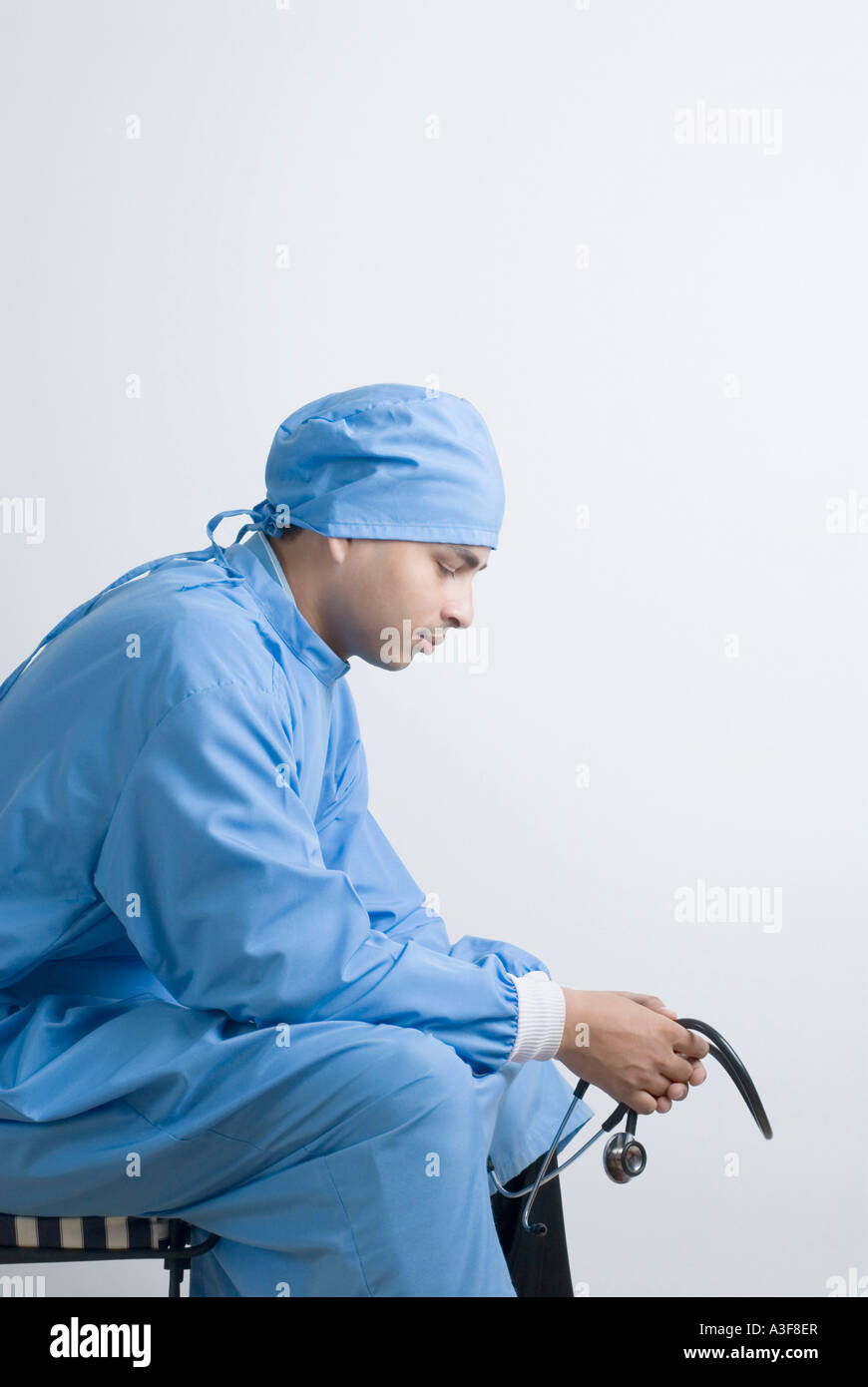 Side profile of a surgeon sitting and thinking Stock Photo - Alamy