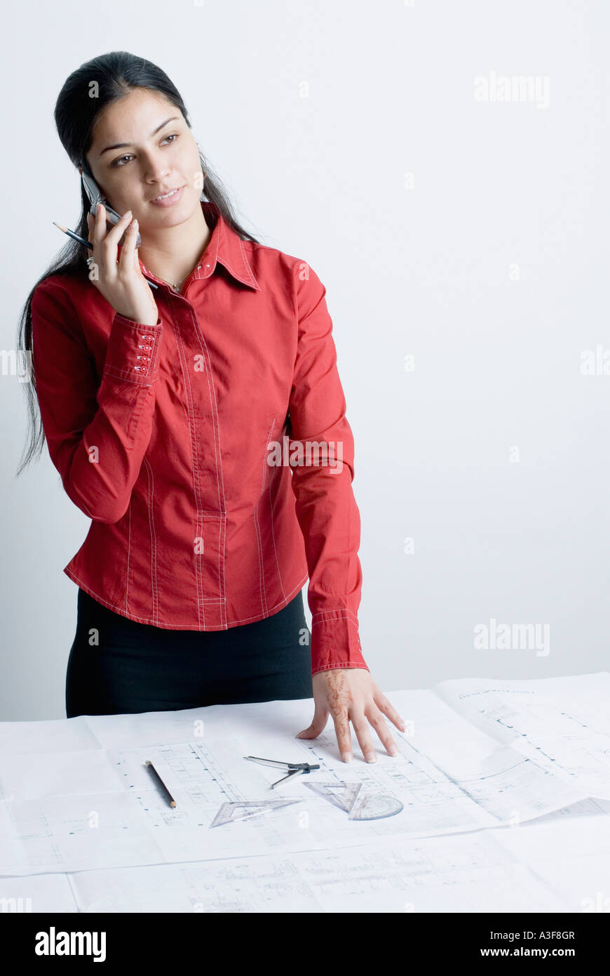 Female architect talking on a mobile phone Stock Photo - Alamy