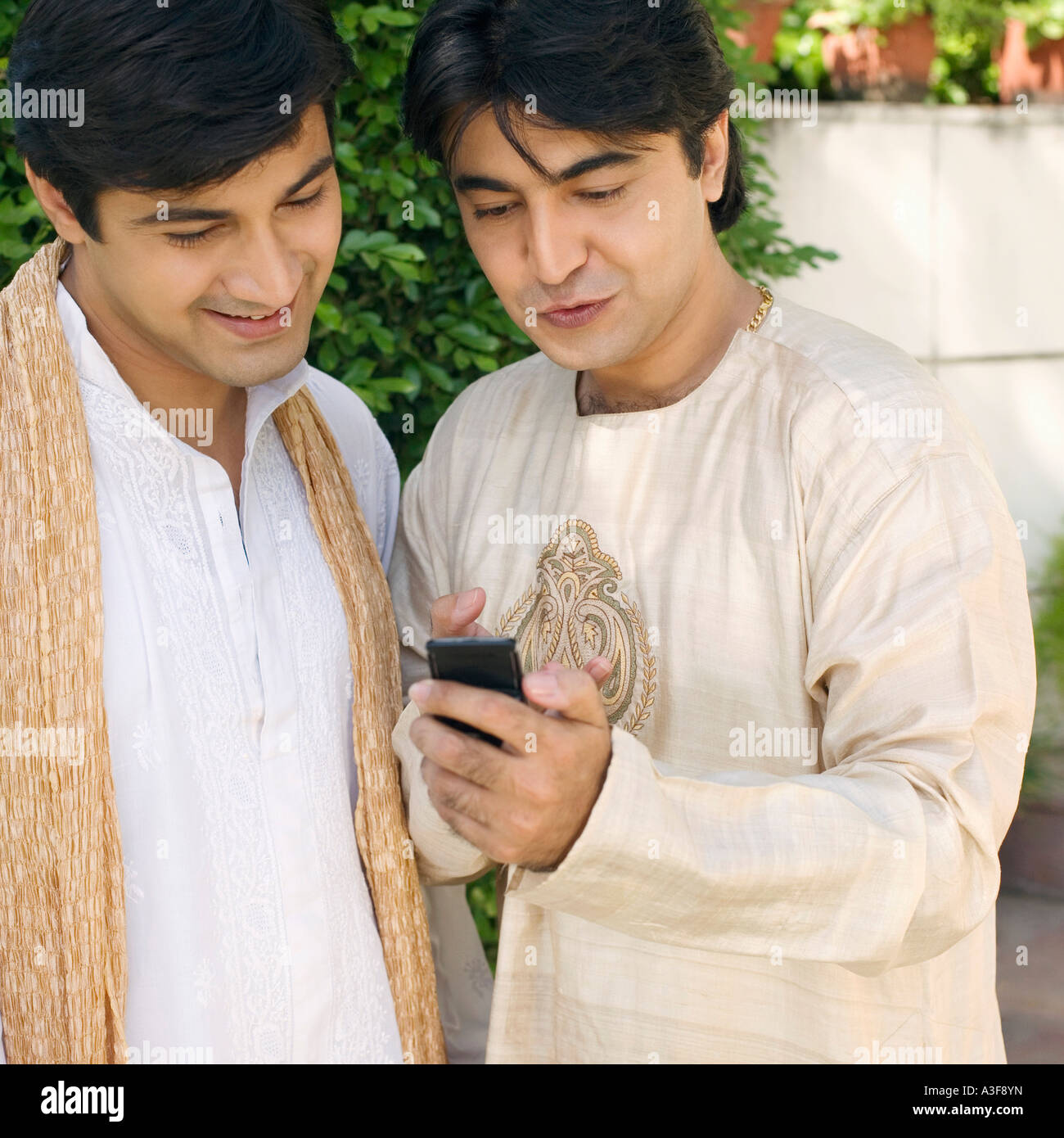 Man showing to another man indian hi-res stock photography and images ...