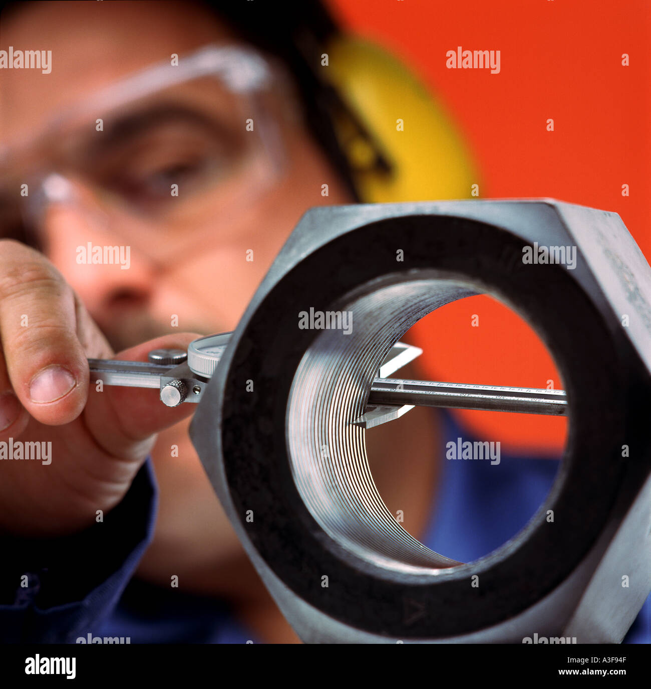 Man uses micrometer to meaure industrial nut Stock Photo - Alamy