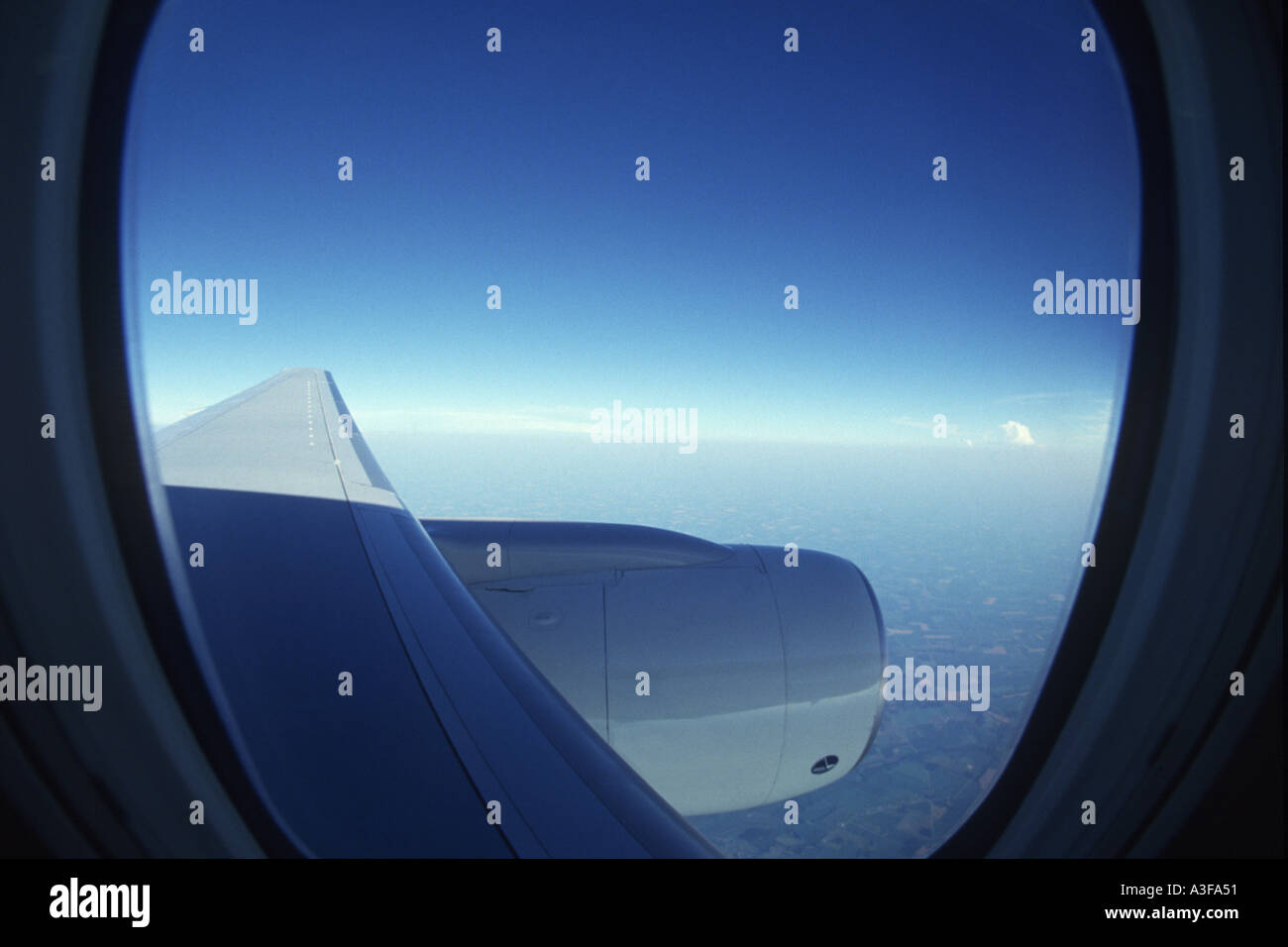 Looking out the window of a jetplane above the clouds Stock Photo - Alamy