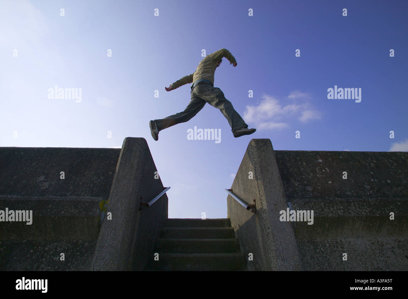 jumping over gap Stock Photo - Alamy