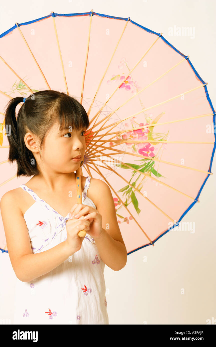 Close-up of a girl holding a parasol Stock Photo - Alamy