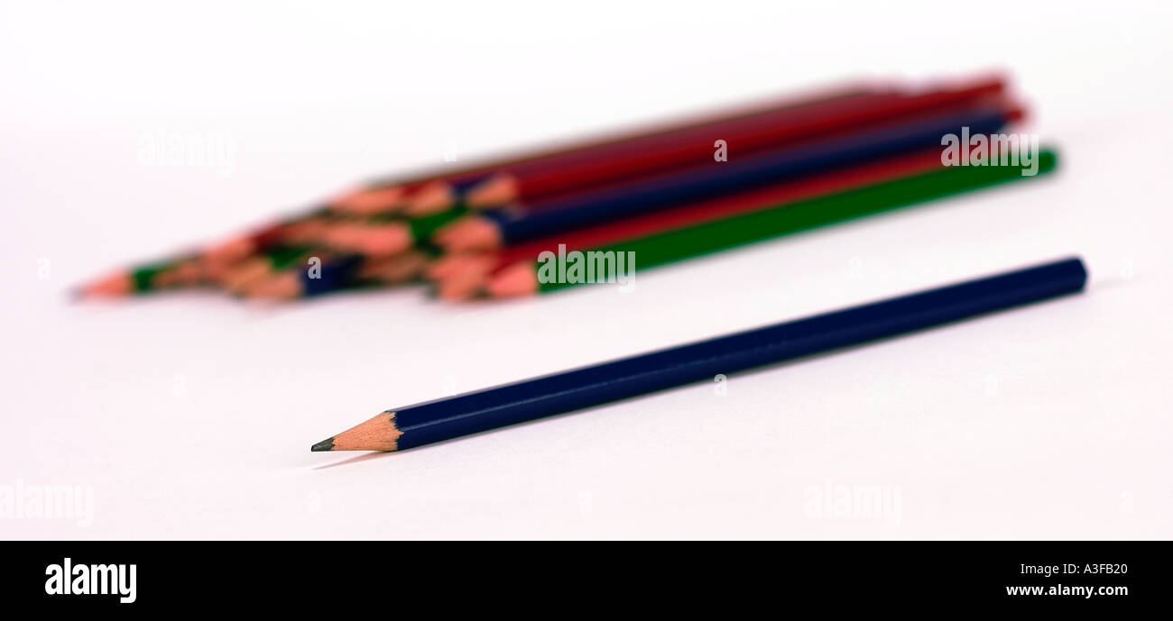 GREEN RED BLUE PENCILS IN BACKGROUND WITH ONE BLUE PENCIL IN FOREGROUND ...