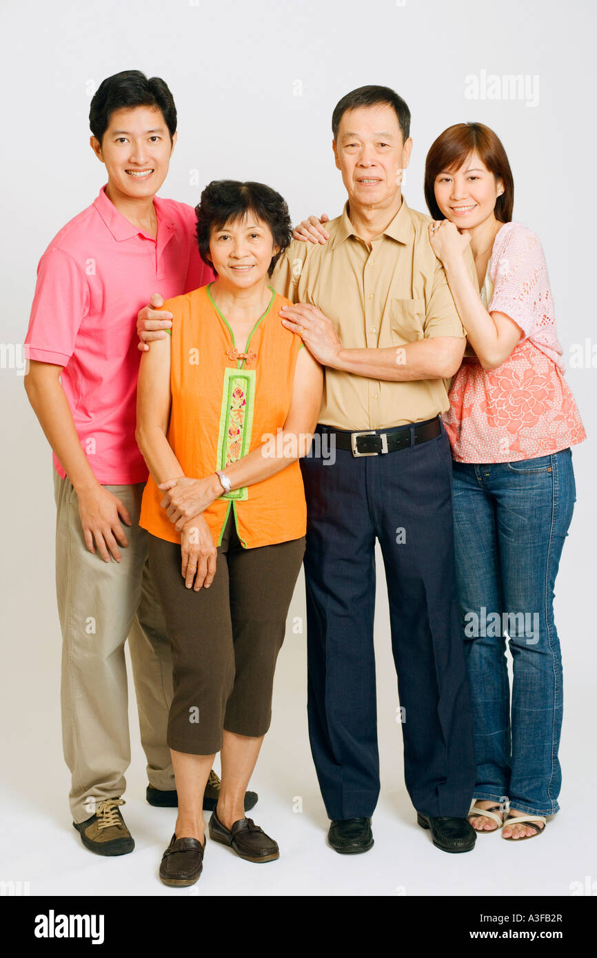 Portrait of a young couple standing with their parents Stock Photo - Alamy