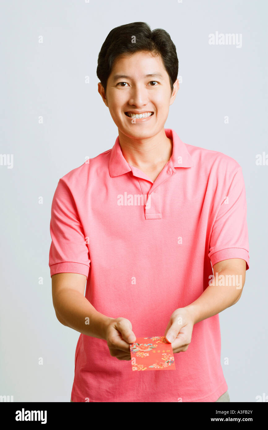 Portrait of a young man holding a greeting card Stock Photo - Alamy