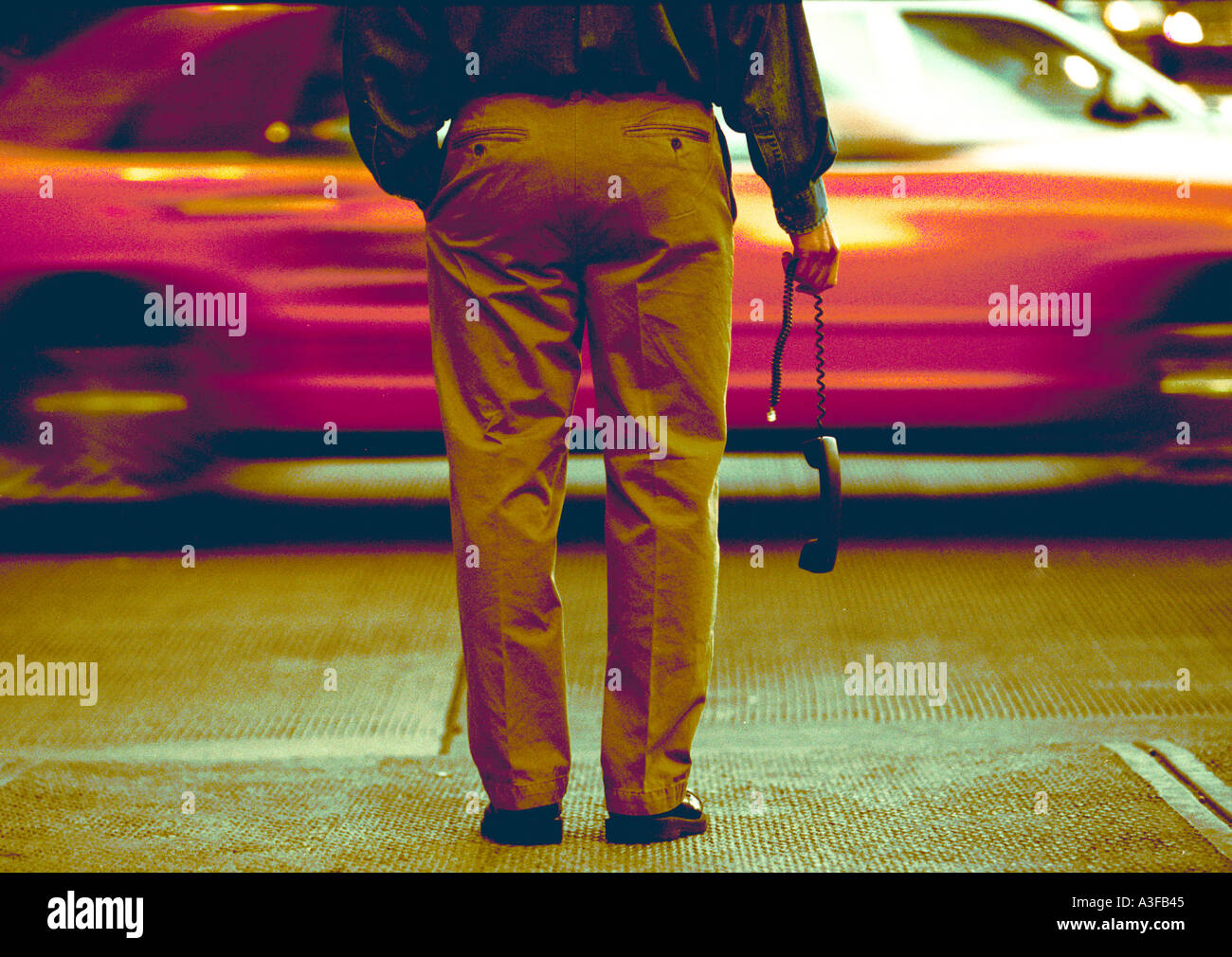 Man holds disconnected phone on street while taxi speeds by Stock Photo ...