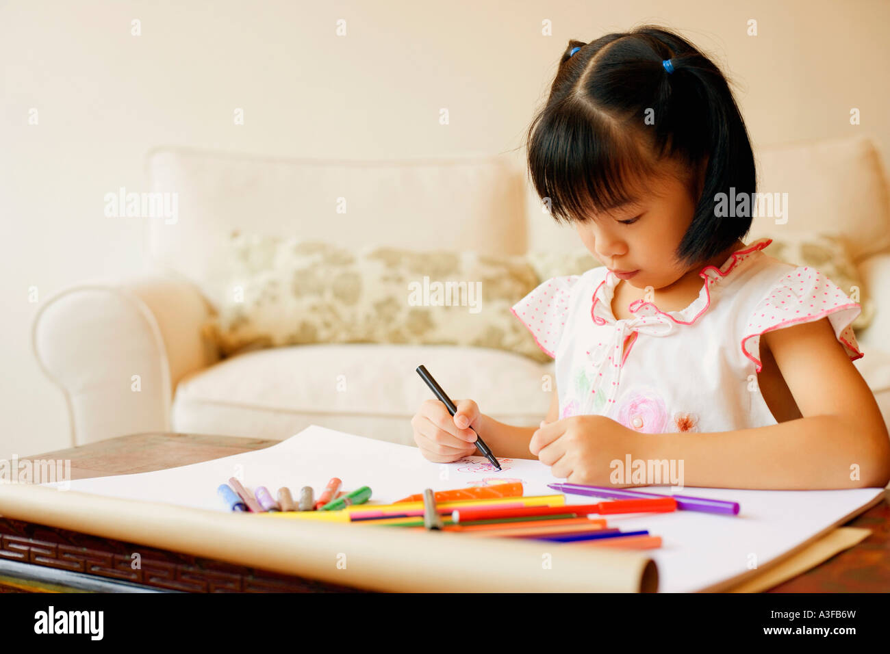 Girl drawing in a coloring book Stock Photo - Alamy