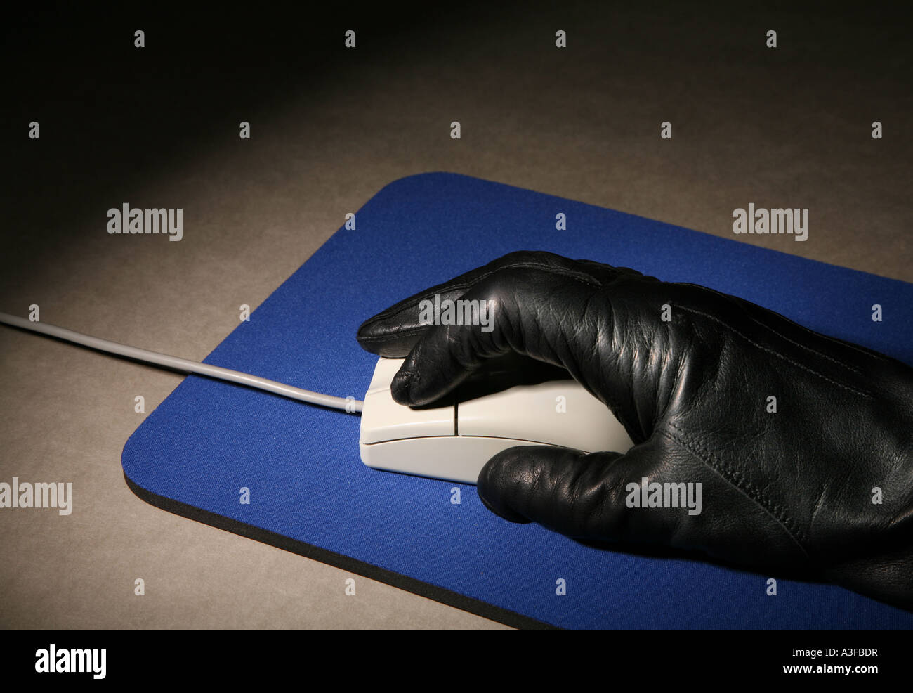 Concept of Cyber Theft a black gloved hand on a mouse secretly sealing ...