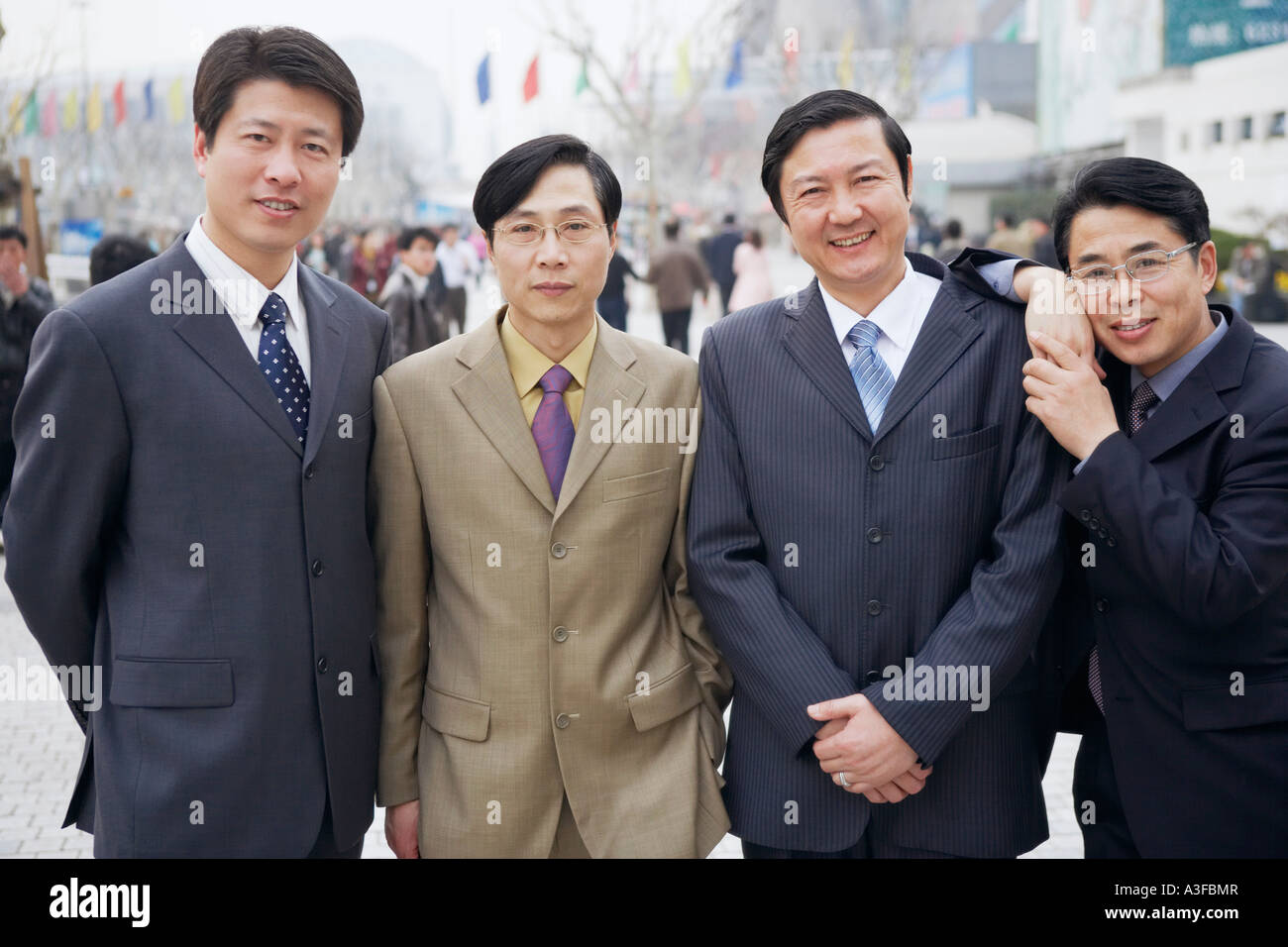 Portrait of four businessmen standing together Stock Photo - Alamy