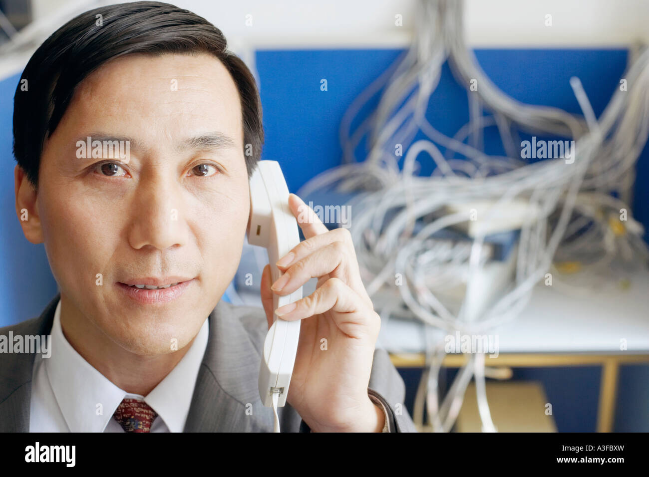Portrait of a businessman using a telephone in a server room Stock ...
