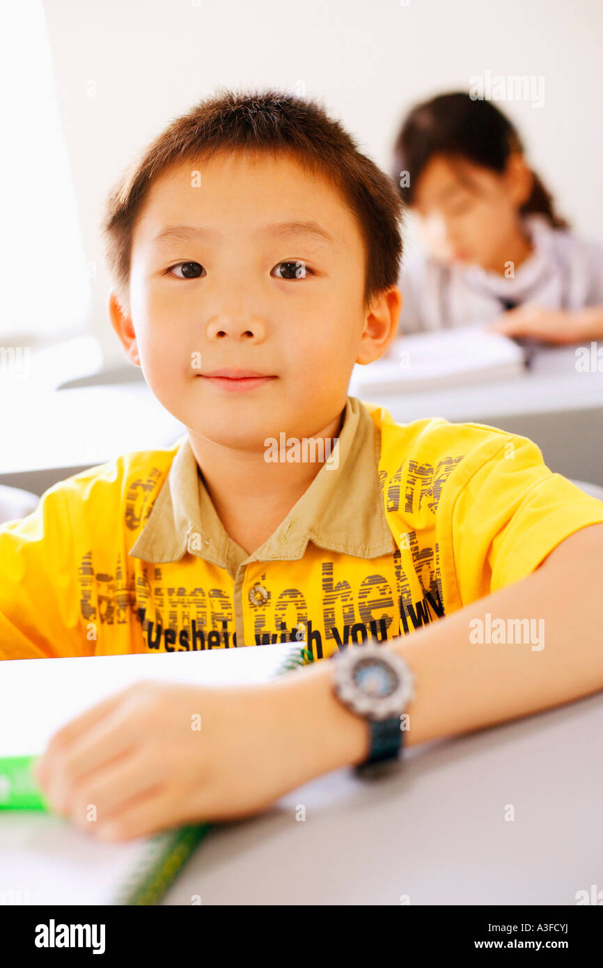 Portrait of a boy sitting in a classroom Stock Photo - Alamy