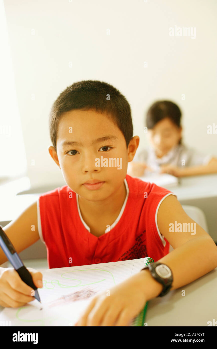 Child portrait writing pen concentrate hi-res stock photography and ...