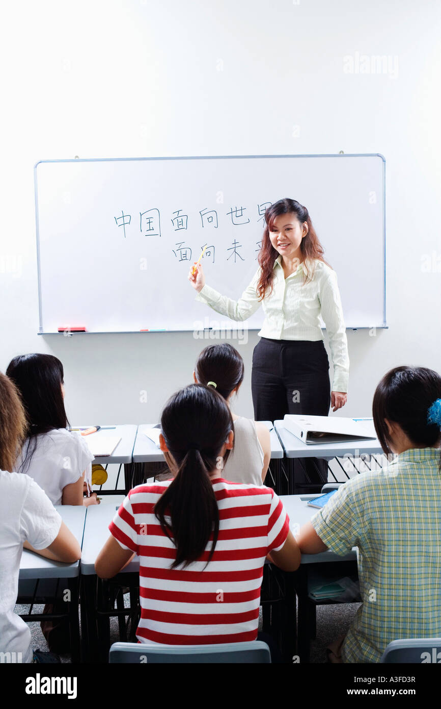 Professor giving lecture to students in the classroom Stock Photo - Alamy