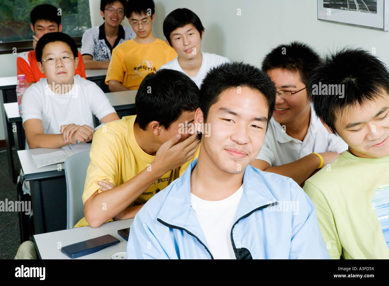 Group of teenage boys sitting in a classroom and smiling Stock Photo ...