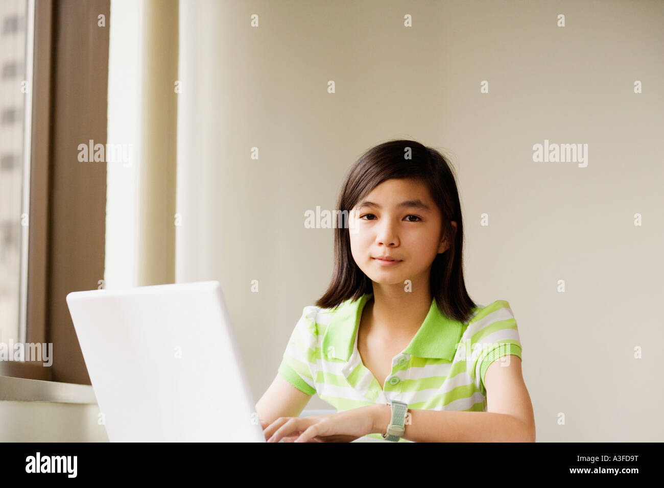 Portrait of a girl using a laptop Stock Photo - Alamy