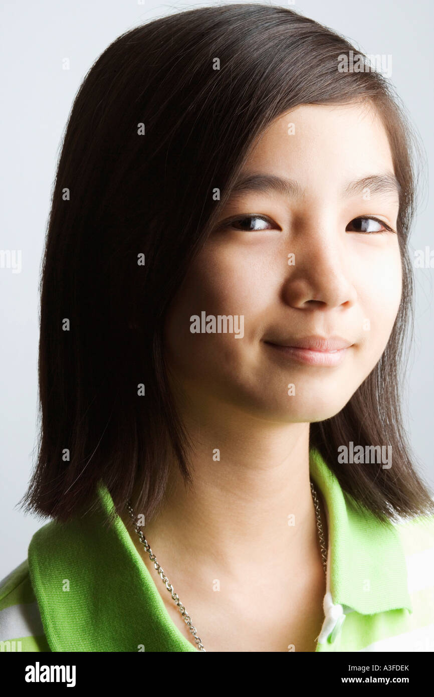Portrait of a teenage girl smirking Stock Photo - Alamy