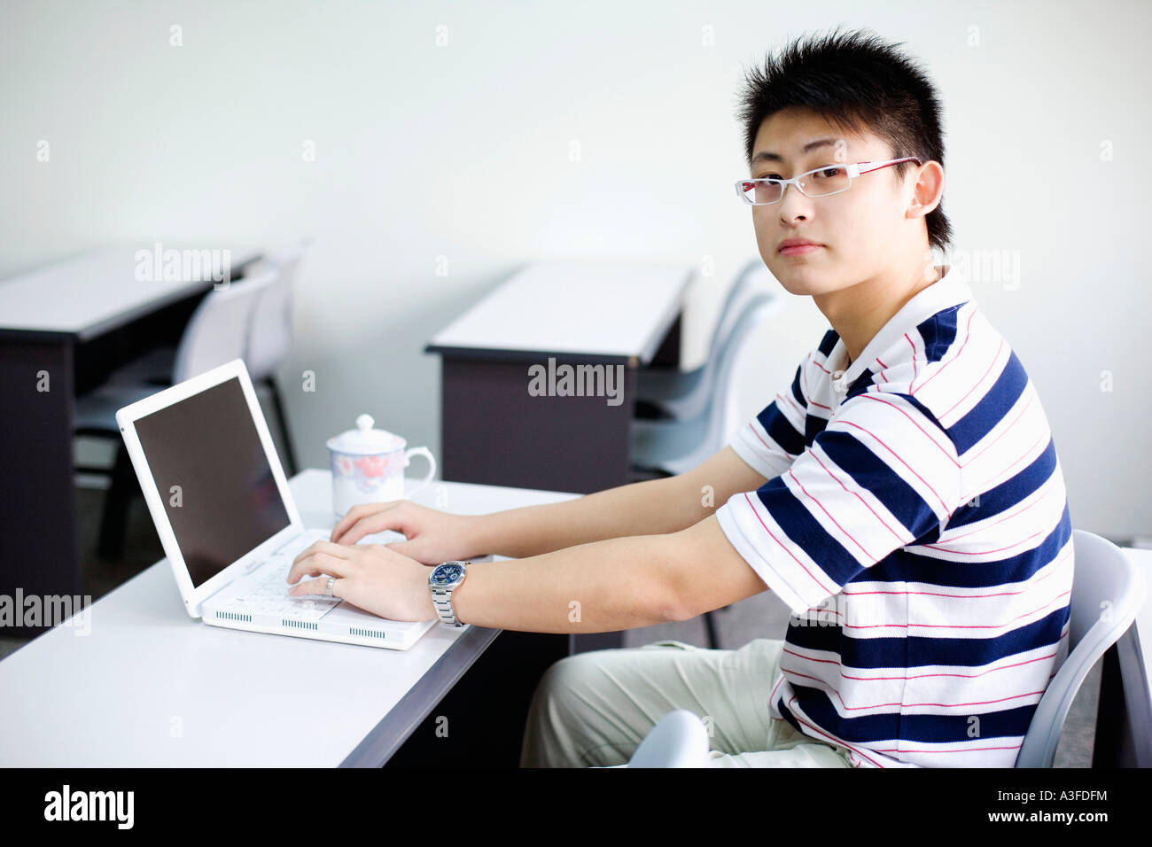 Portrait of a young man using a laptop Stock Photo - Alamy