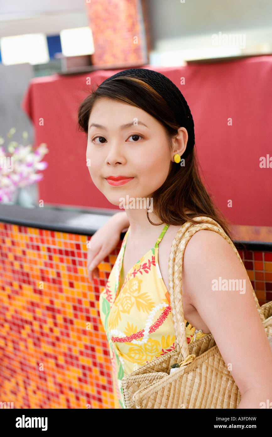 Portrait of a young woman carrying a purse Stock Photo - Alamy