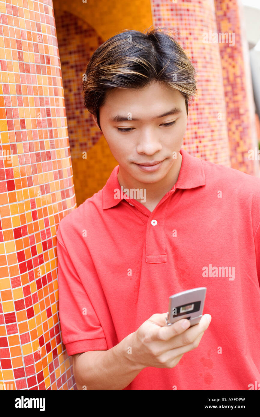 Close-up of a young man using a mobile phone Stock Photo - Alamy