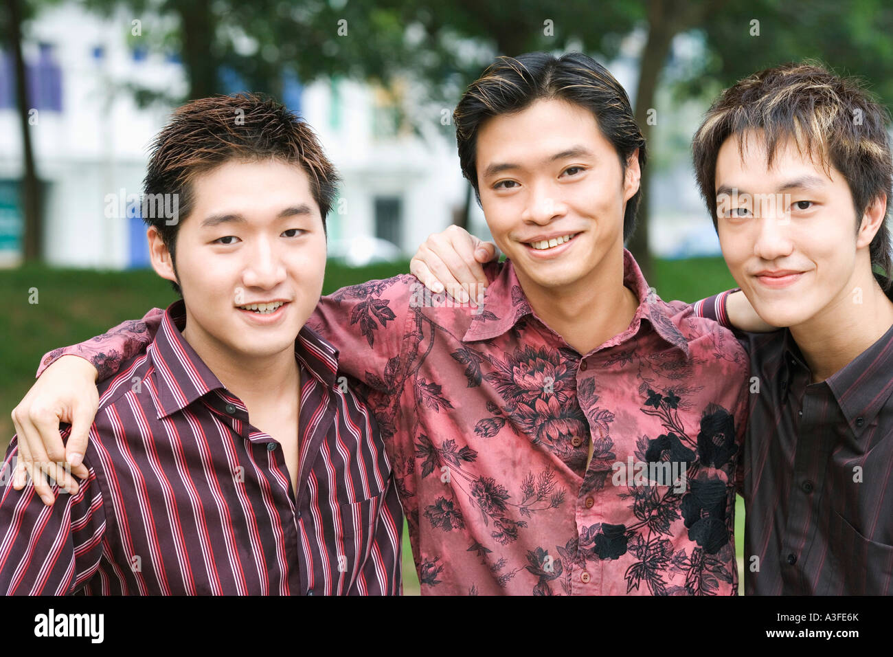 Portrait of three young men smiling Stock Photo - Alamy