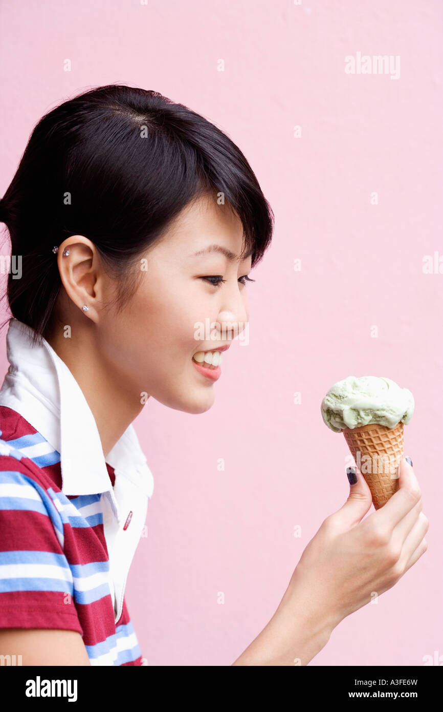 Side profile of a young woman holding an ice-cream cone Stock Photo - Alamy