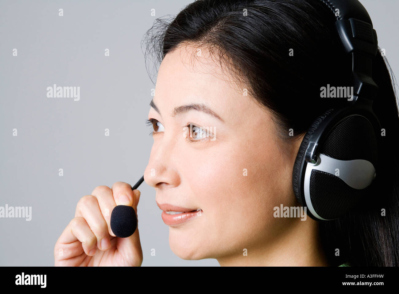 Side profile of a businesswoman using a headset Stock Photo - Alamy