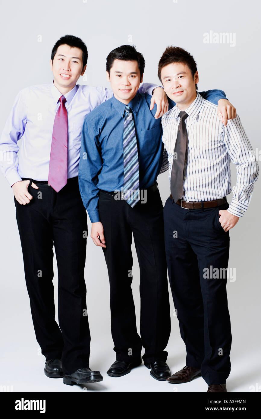 Portrait of three businessmen standing and smiling Stock Photo - Alamy