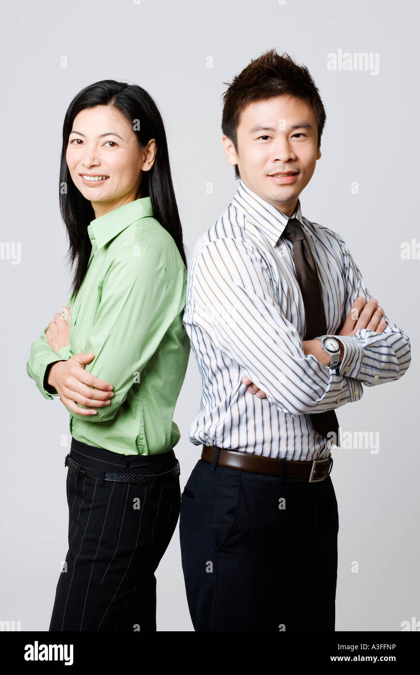 Side profile of a young businessman and a businesswoman standing back ...