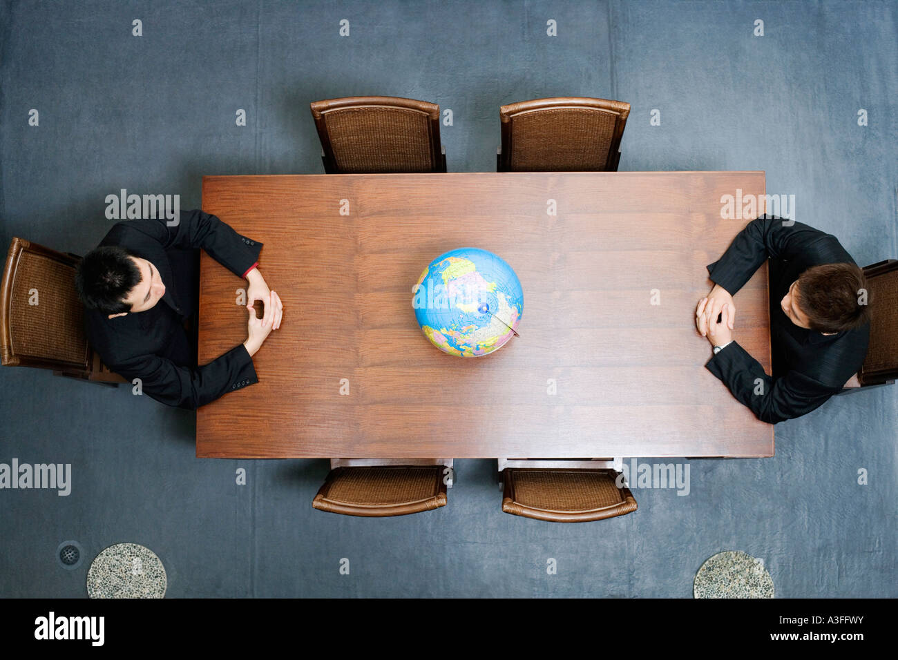 High angle view of two businessmen sitting at a conference table Stock ...