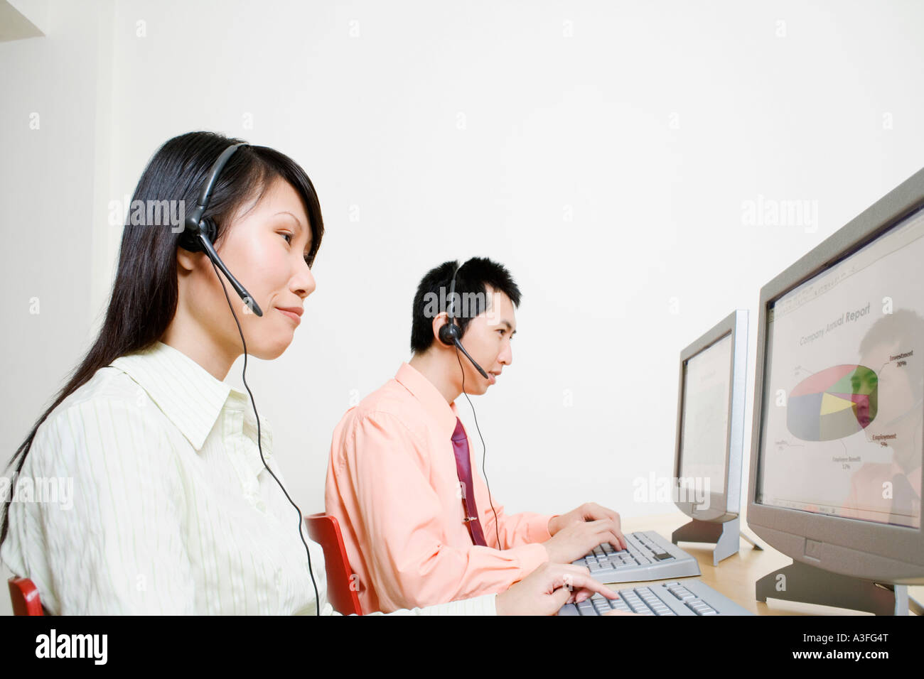 Two customer service representatives working on a computer Stock Photo - Alamy