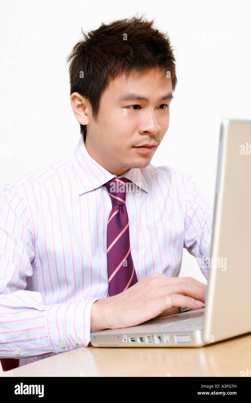 Attentive male executive using laptop hi-res stock photography and ...