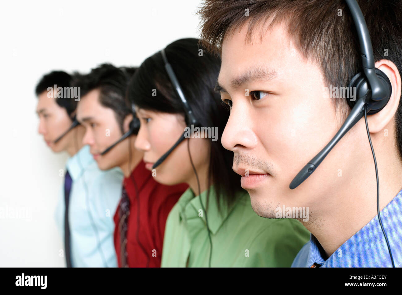 Four customer service representatives talking on headsets Stock Photo ...