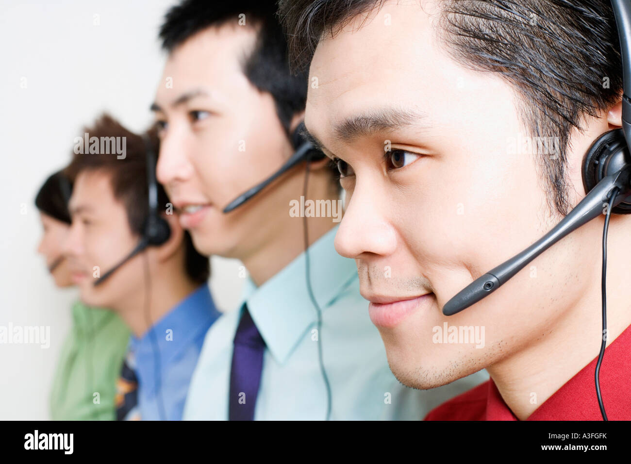 Four customer service representatives talking on headsets Stock Photo ...
