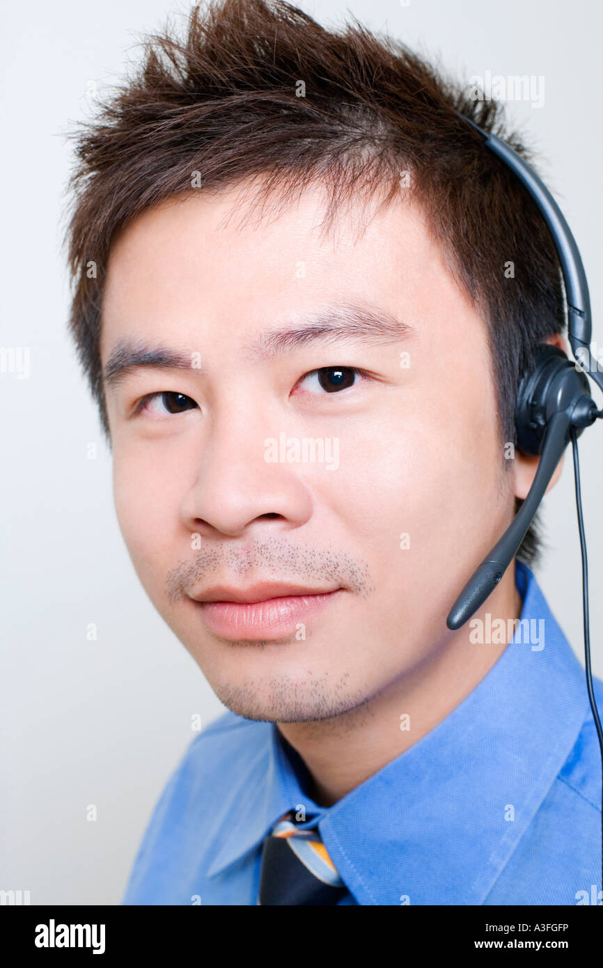 Portrait of a male customer service representative using a headset ...