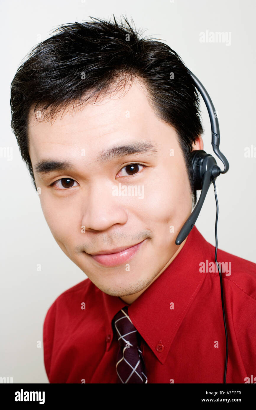 Portrait of a male customer service representative using a headset ...