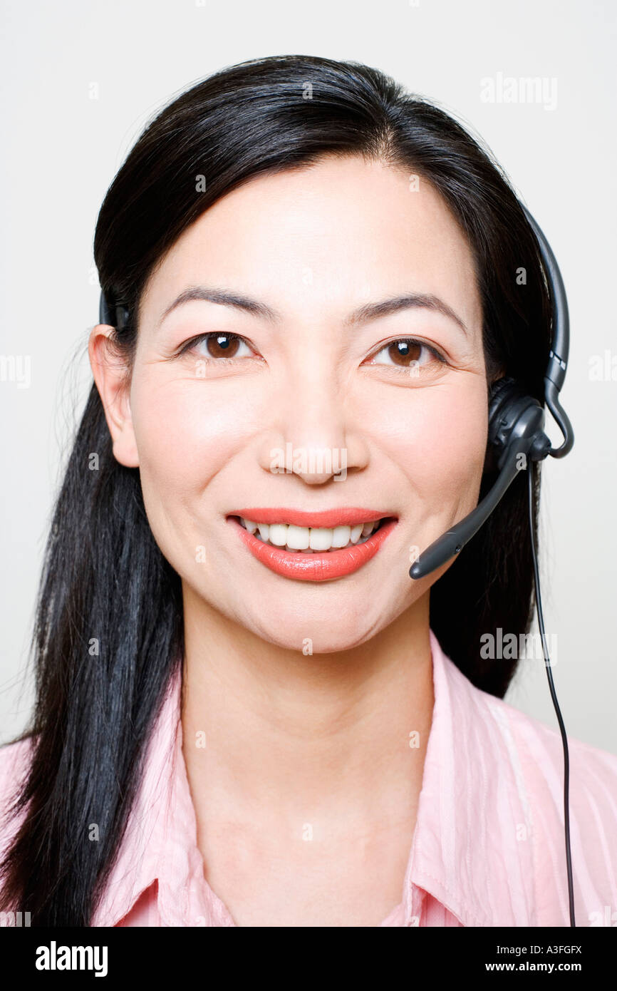 Portrait of a female customer service representative using a headset ...