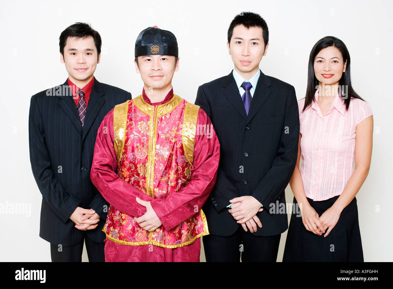 Portrait of three business executives and a young man standing together ...