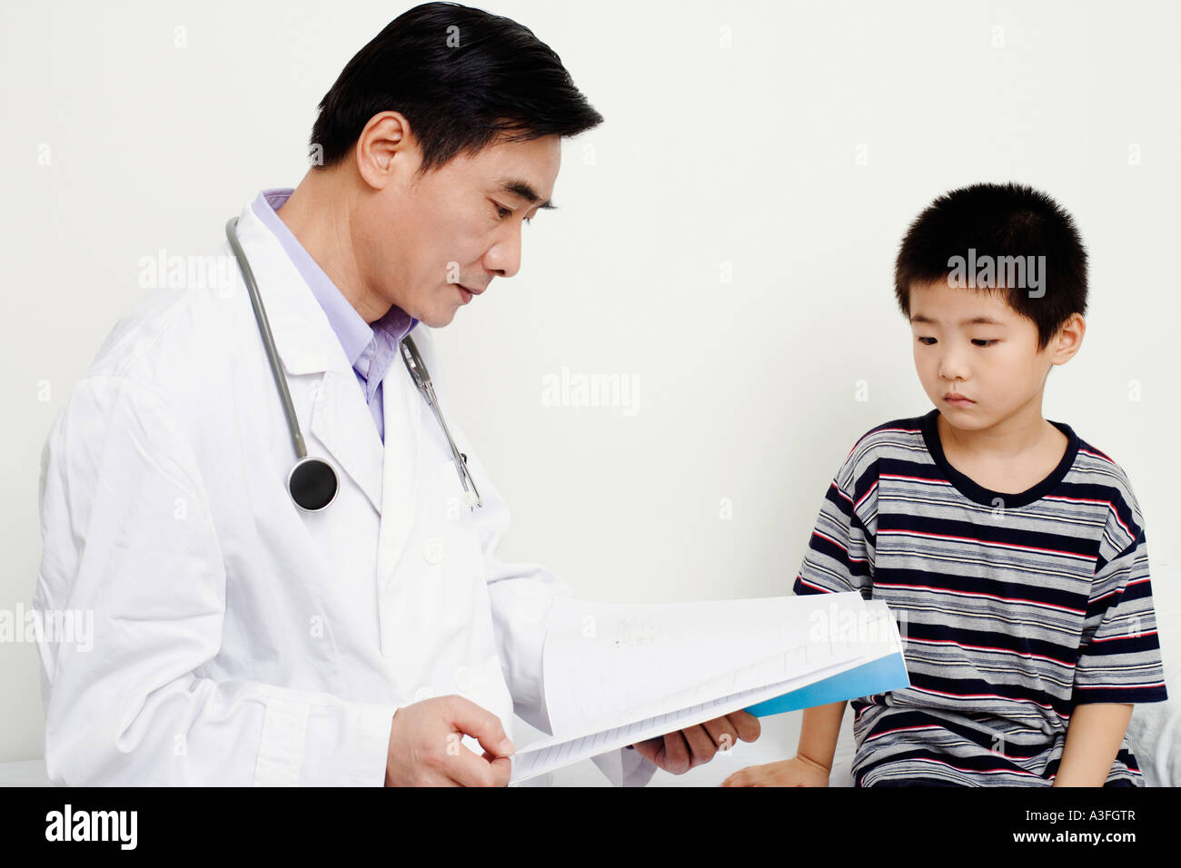 Close-up of a doctor looking at a medical report Stock Photo - Alamy