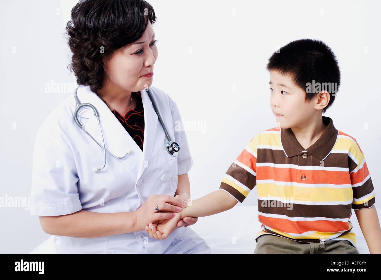 Doctor checking pulse child hi-res stock photography and images - Alamy