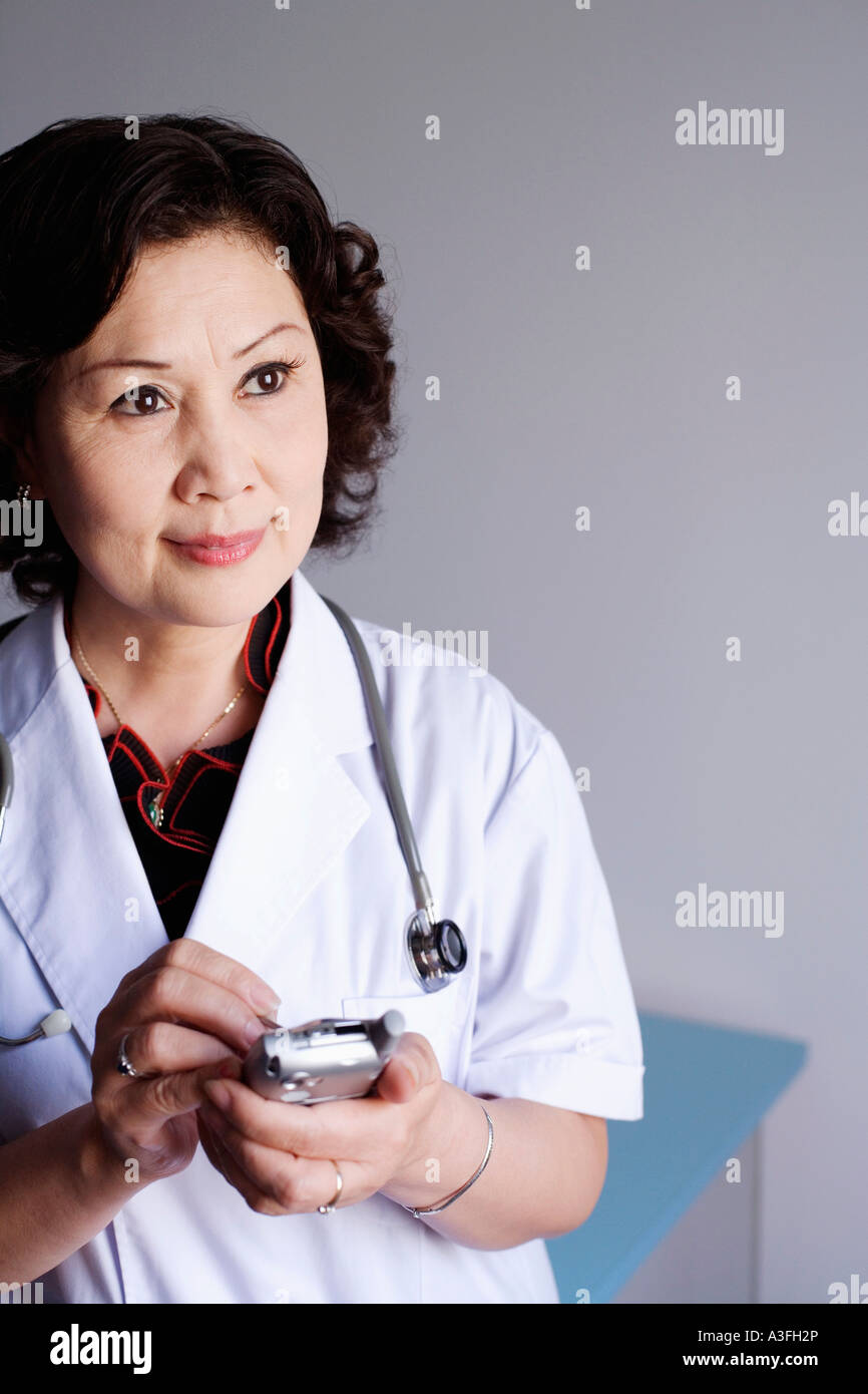 Close-up of a female doctor holding a personal data assistant Stock ...