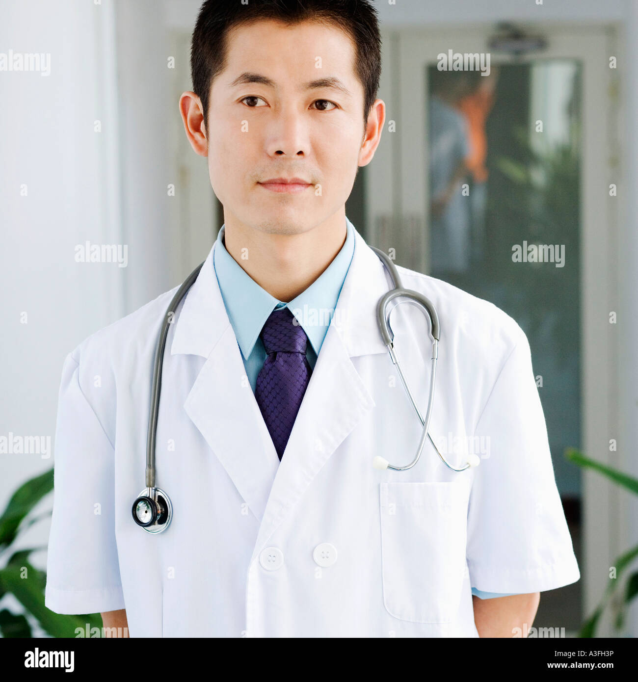 Doctor standing behind glass hi-res stock photography and images - Alamy