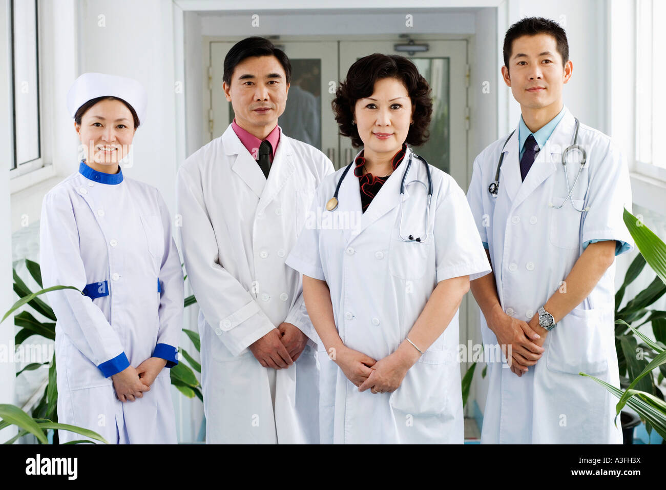 Portrait of three doctors and a nurse standing together Stock Photo - Alamy