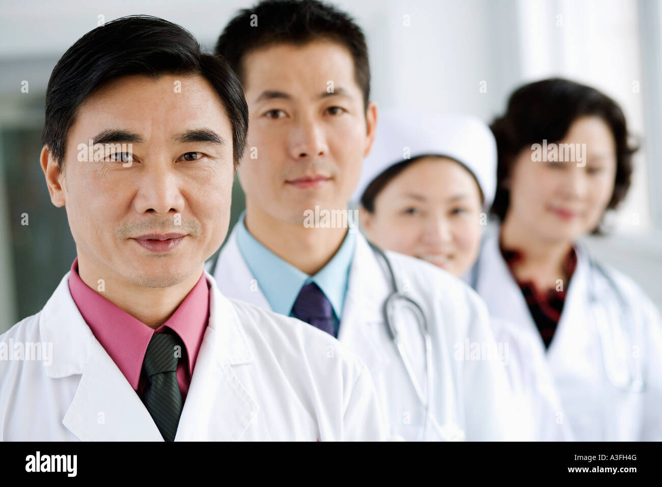 Portrait of three doctors with a nurse Stock Photo - Alamy
