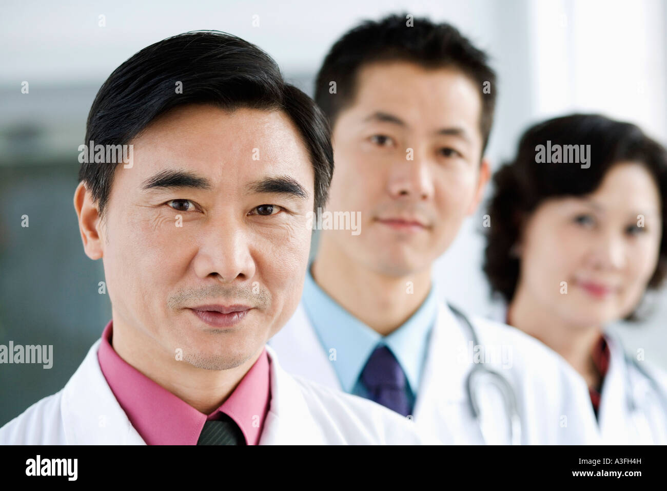 Portrait of two male doctors with a female doctor Stock Photo - Alamy